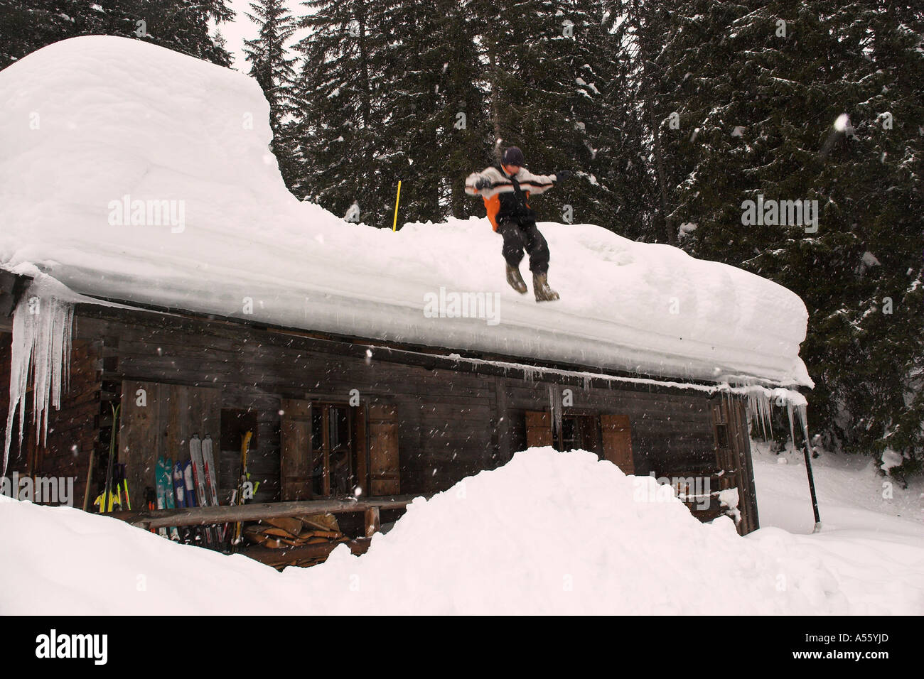 MR Boy jumping from a roof into snow Stock Photo - Alamy