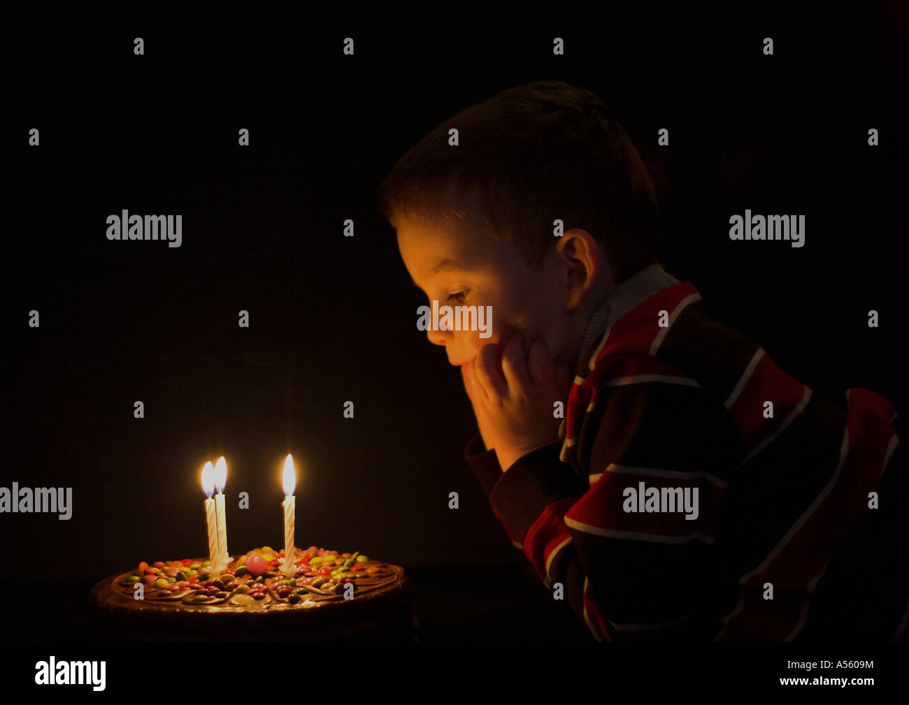 Boy with candles Stock Photo - Alamy