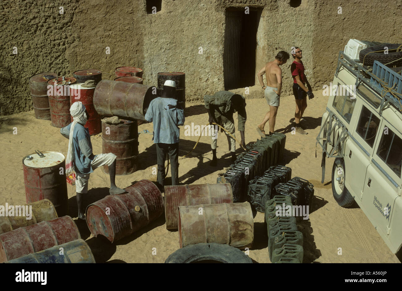 Filling up the tank and Jerry cans by siphon Bilma Ténéré desert Sahara ...
