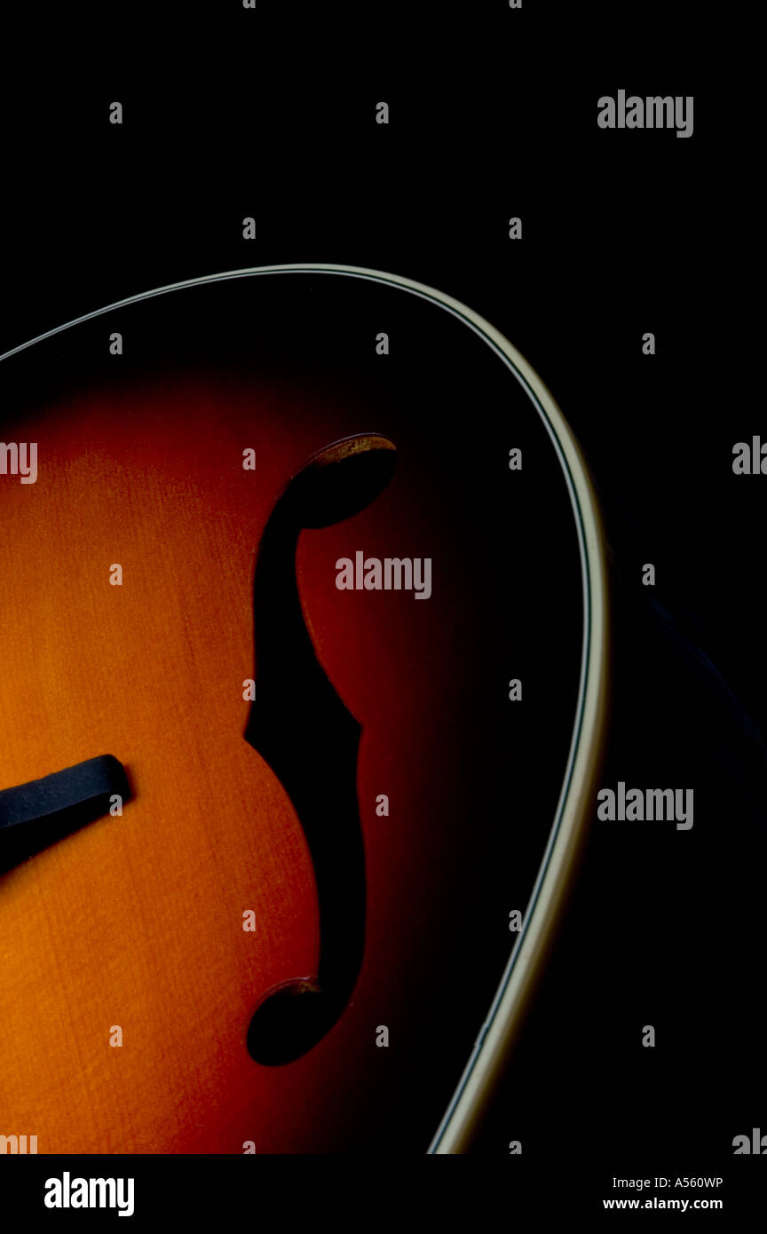 Close up of mandolin scroll on black reflective background Stock Photo ...