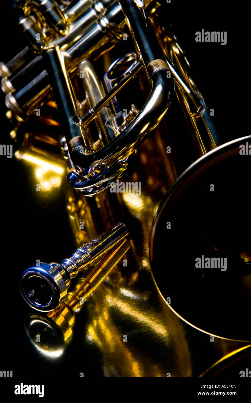 Trumpet(s) on black reflective background Stock Photo - Alamy