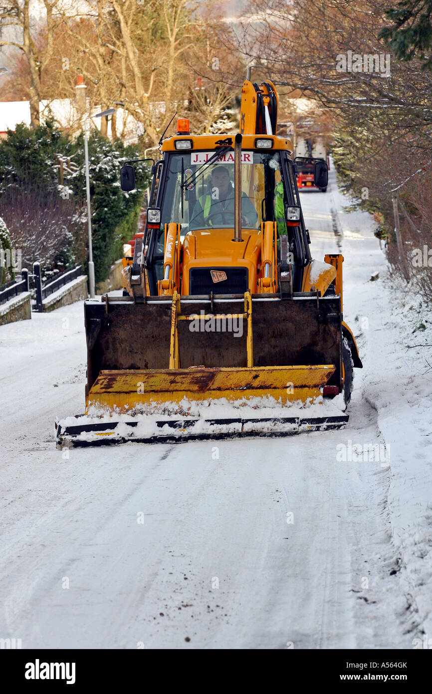 JCB snowplough clearing roads and pavements in Monymusk, Aberdeenshire ...