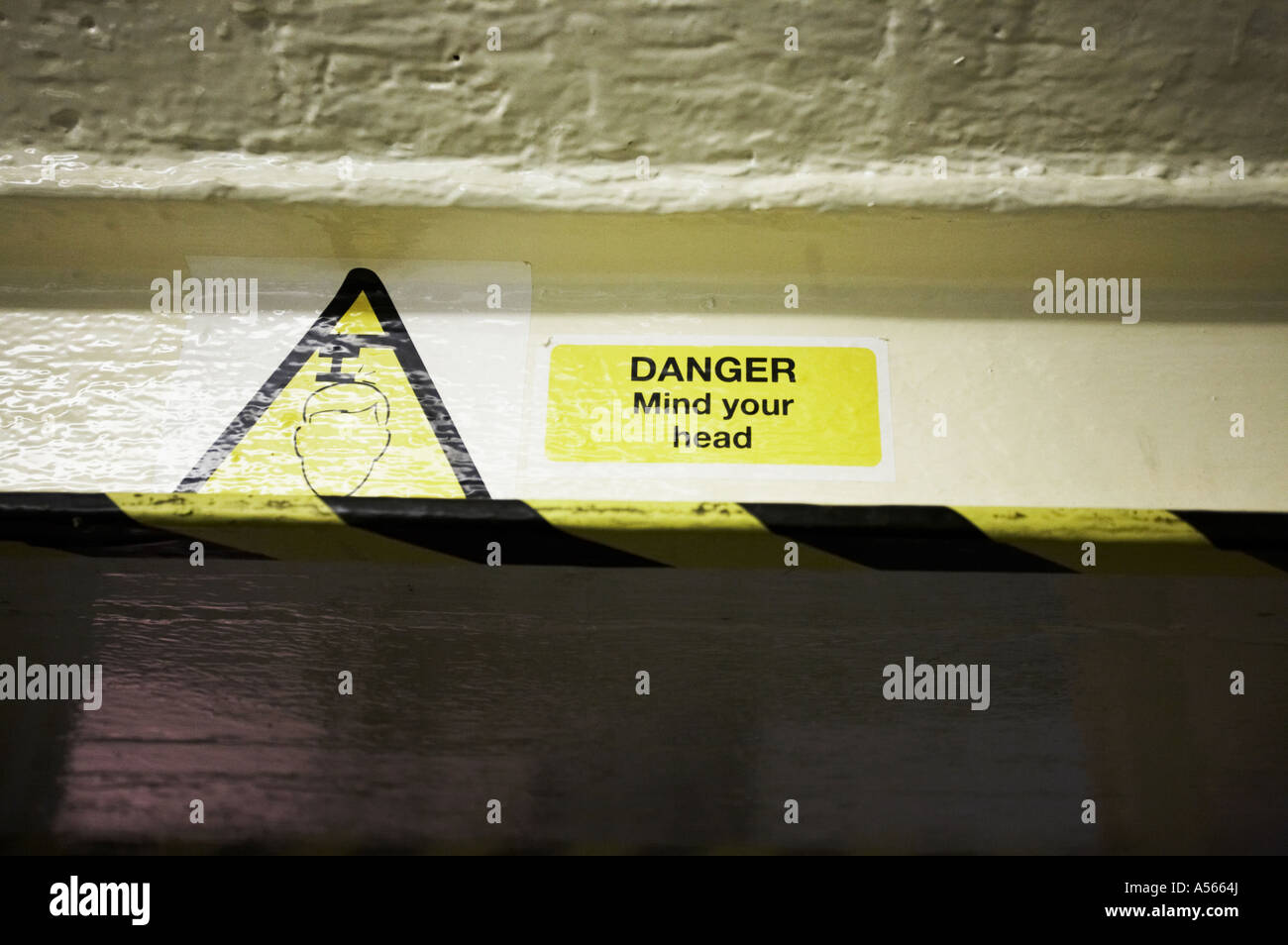 MIND YOUR HEAD Health and safety warning sign Stock Photo - Alamy