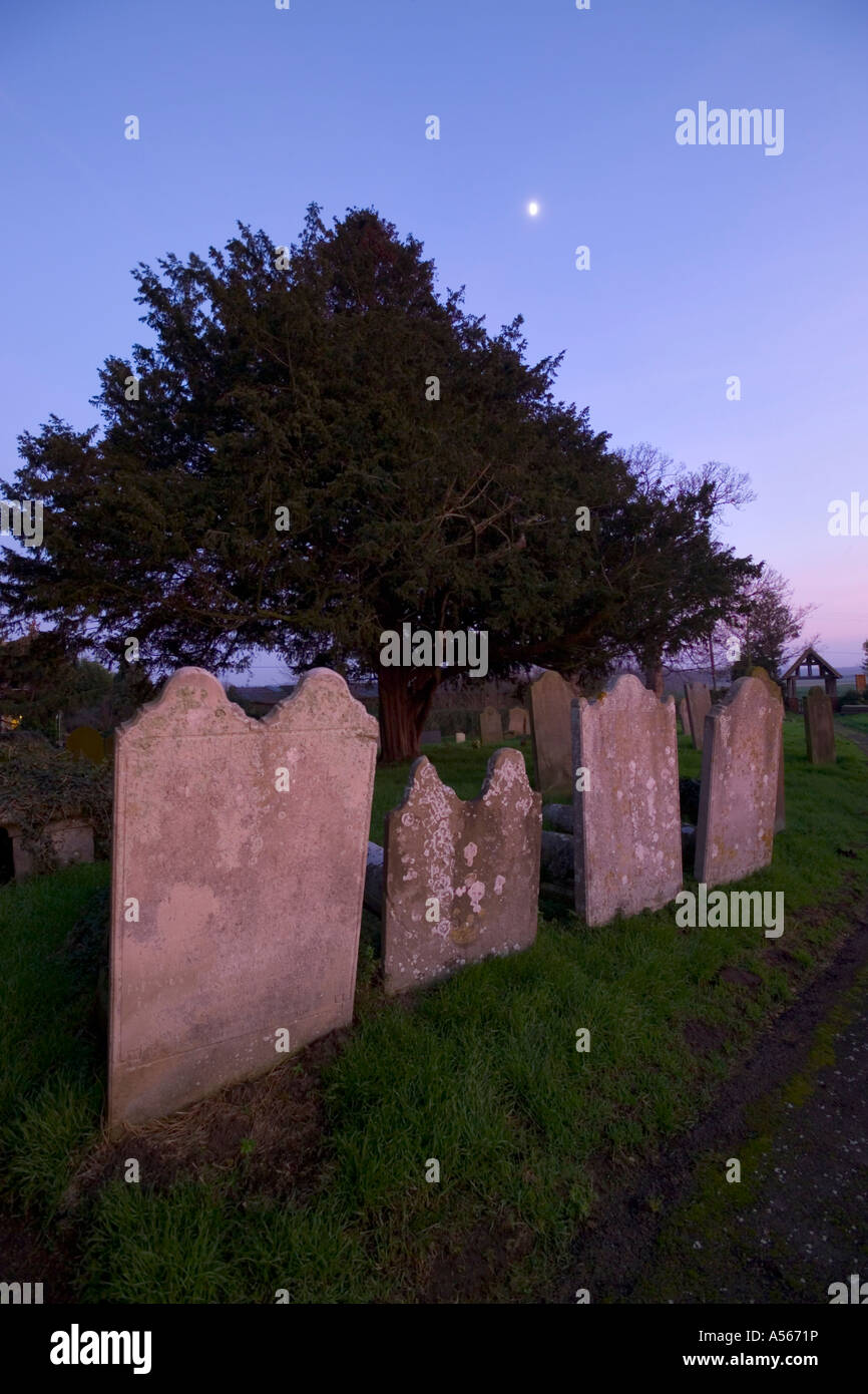 Gravestones in churchyard at night Stock Photo - Alamy