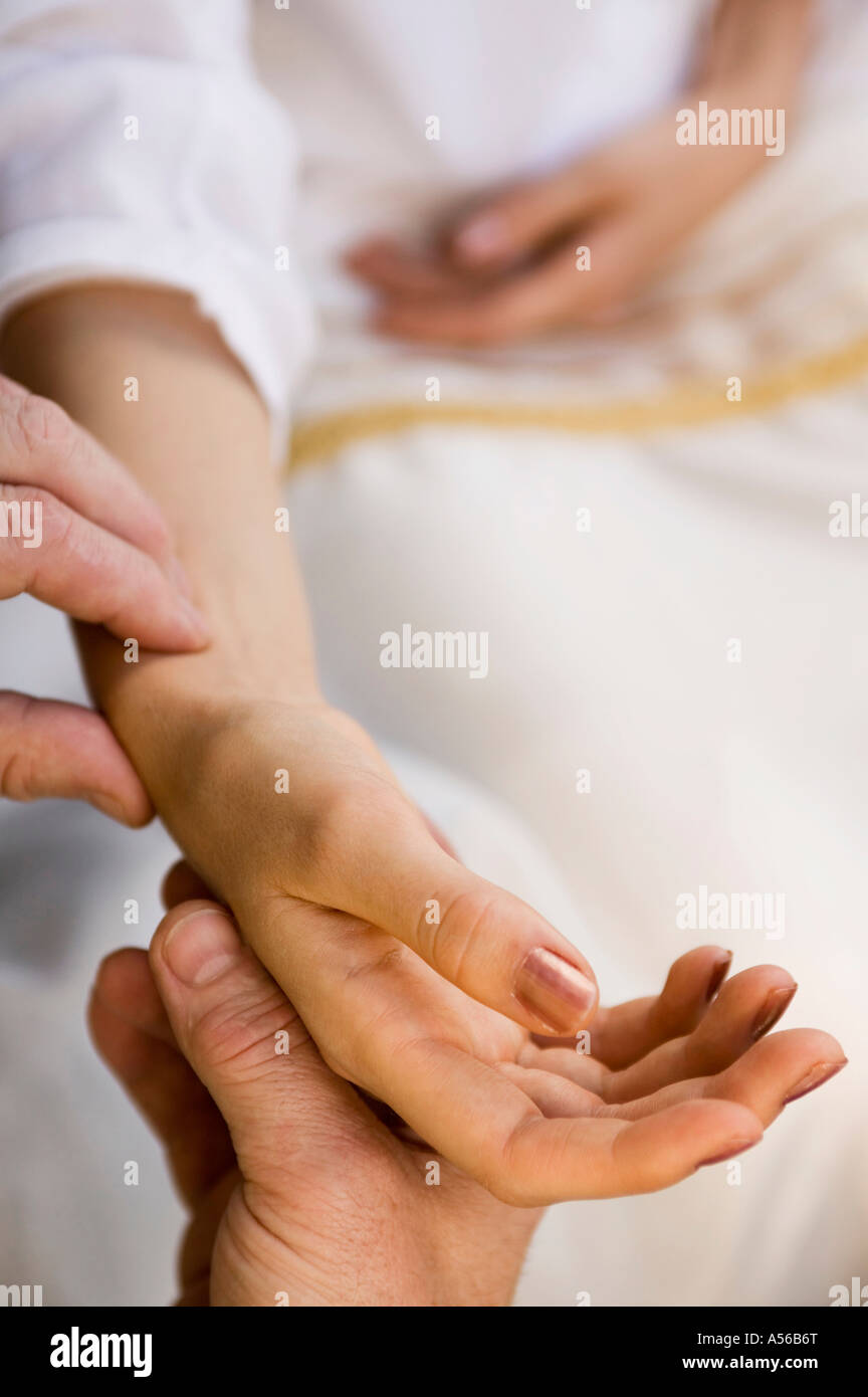 Feeling for pulse hi-res stock photography and images - Alamy