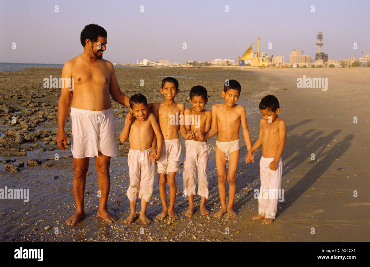 Father and boys on beach Kuwait at sunset Stock Photo - Alamy