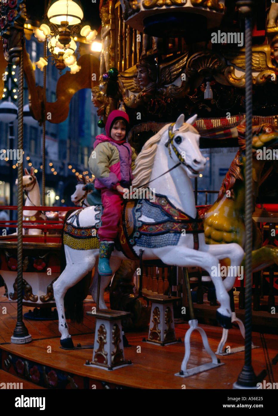 Having a ride on the merry go round Stock Photo - Alamy