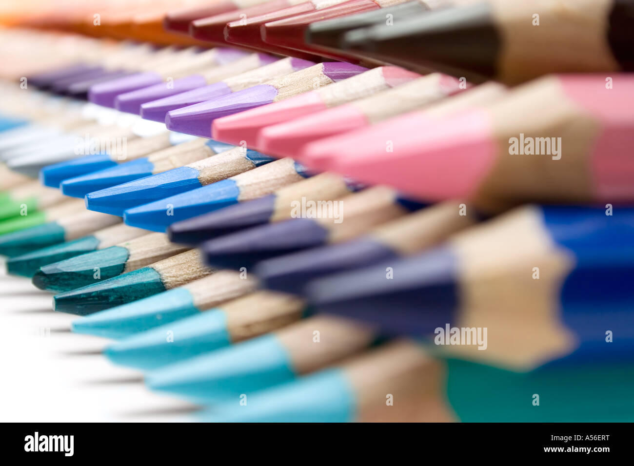 Stacked colored crayons on a white background. Shallow depth of field ...