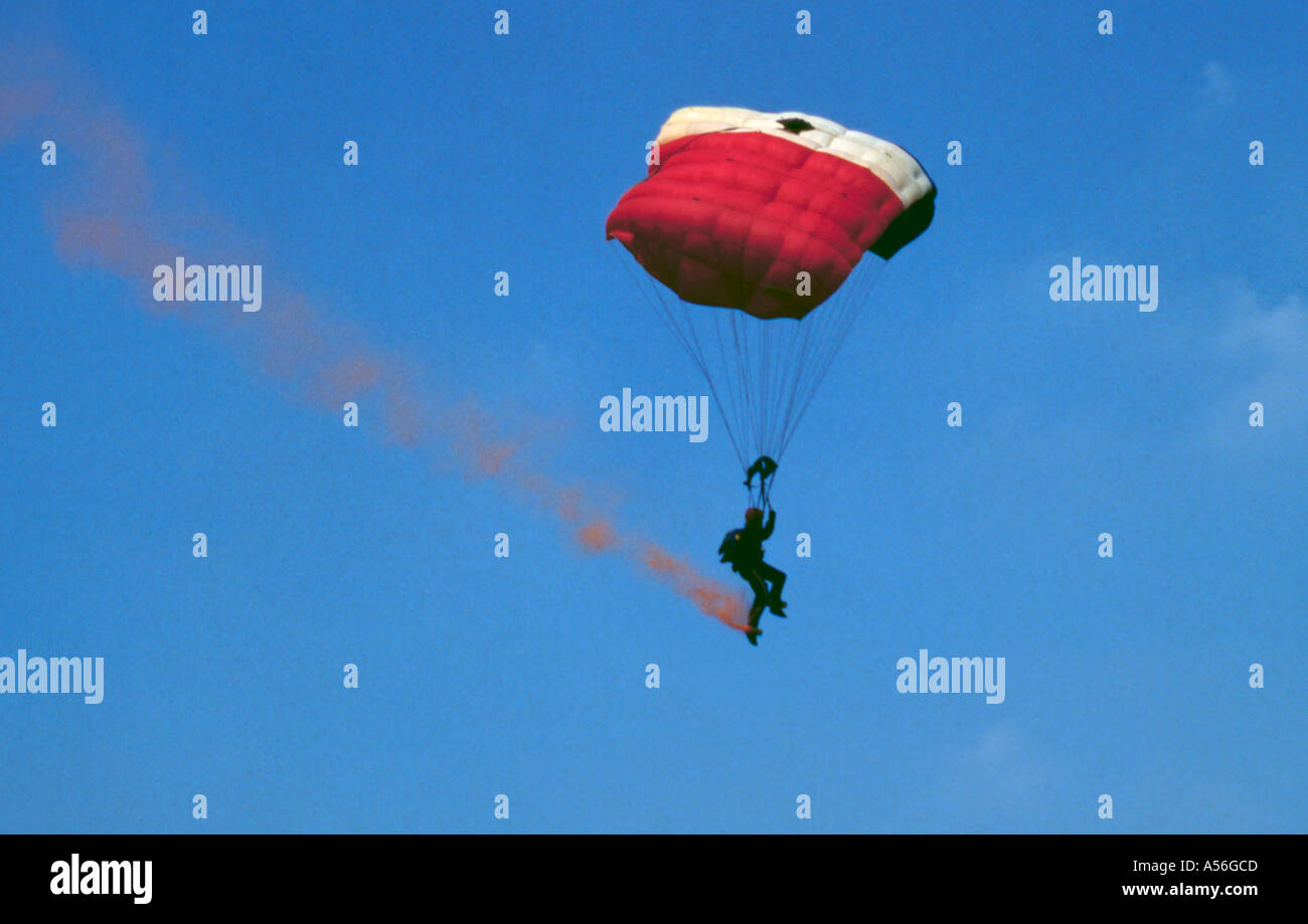 Parachutist descending and trailing smoke Stock Photo - Alamy