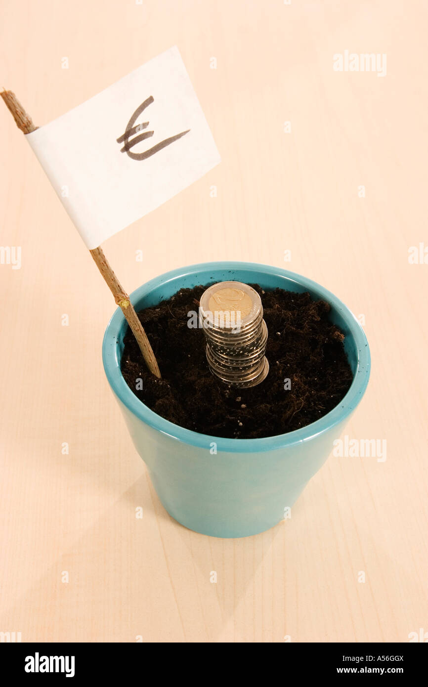 Euro coins in plant pot Stock Photo - Alamy