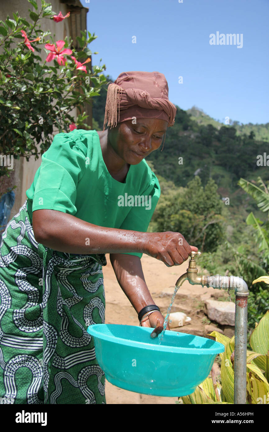 Painet iy8594 tanzania woman female taking water tap safe abundant ...