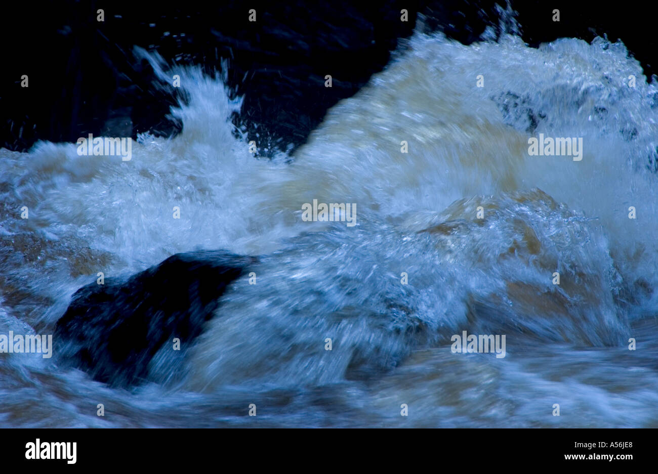 Fast running water and rocks Stock Photo - Alamy