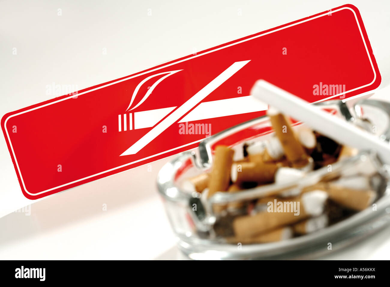 Full ashtray in front of no smoking signboard, tilt view Stock Photo ...
