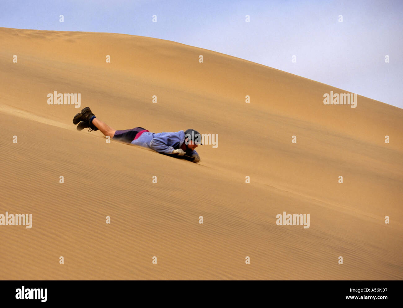 Sand boarding down the dunes, Swakopmund, Namibia Stock Photo - Alamy