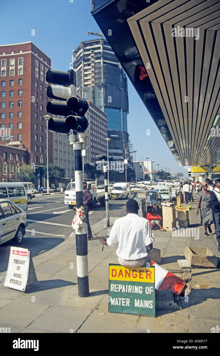 Signs and people in street Harare city centre Zimbabwe Africa Stock ...