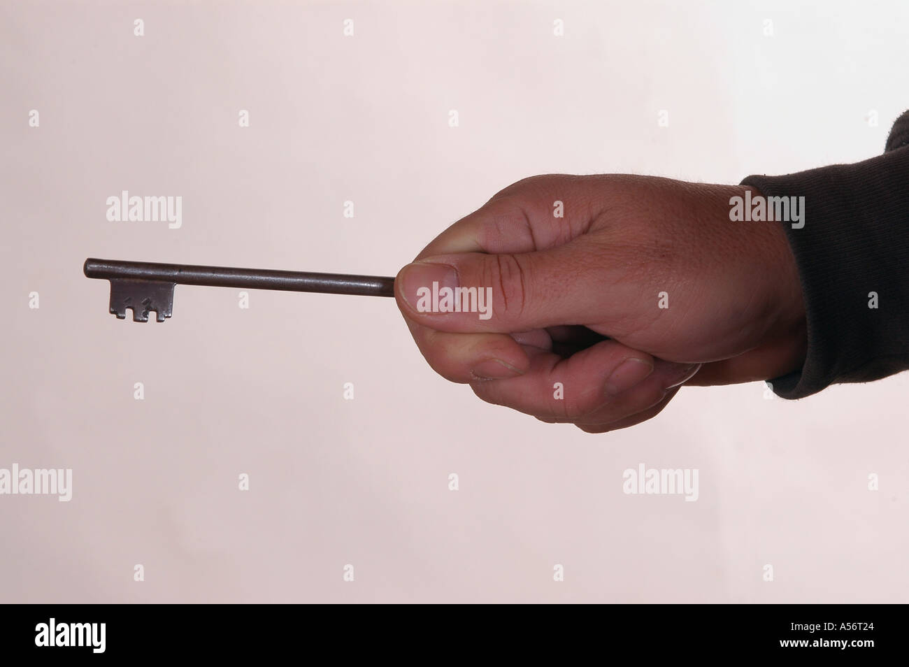 Man hand with old key Stock Photo - Alamy