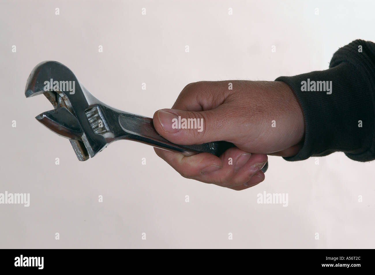Man hand with spanner Stock Photo - Alamy