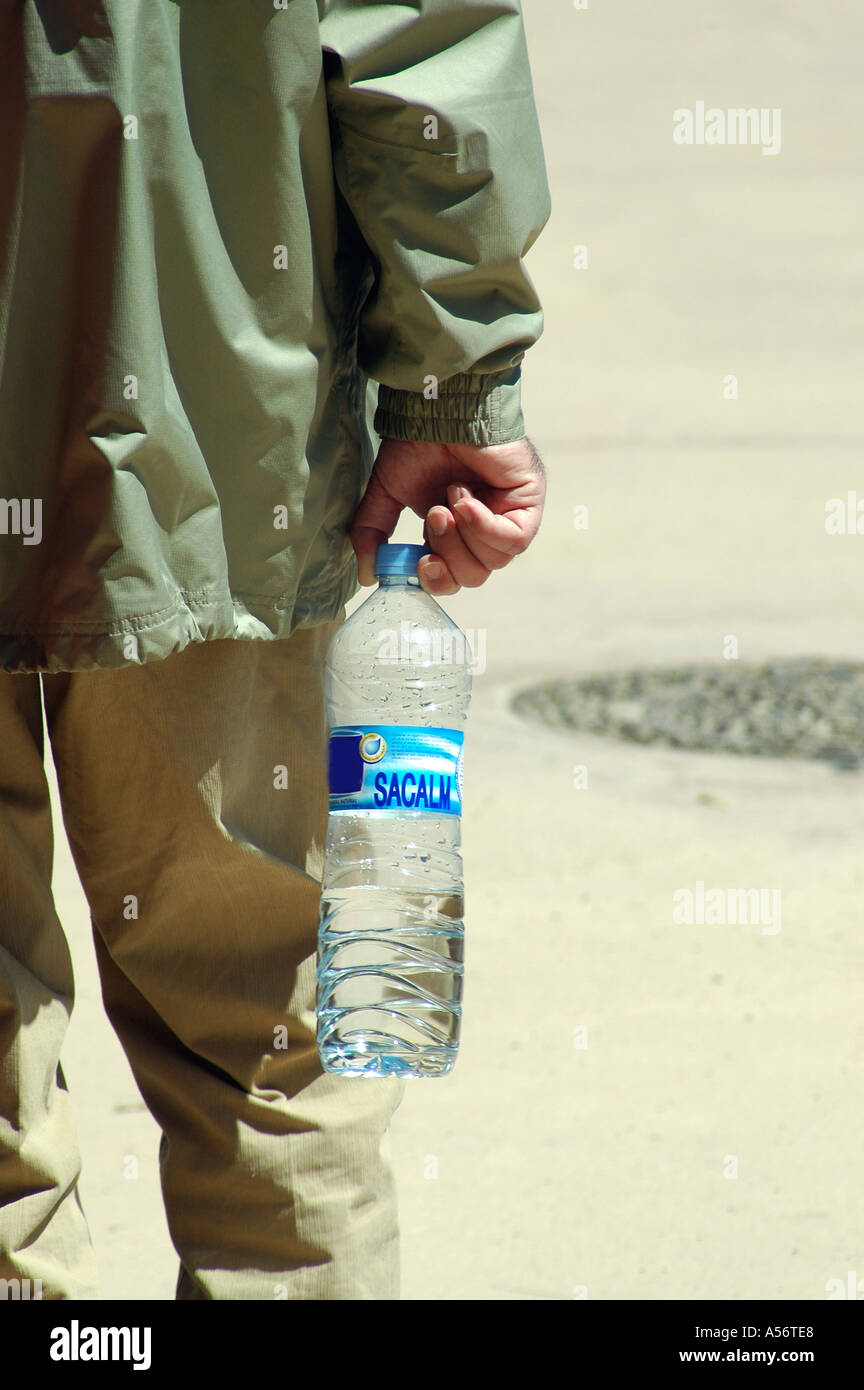 Man walking with a water bottle in the hand Stock Photo - Alamy