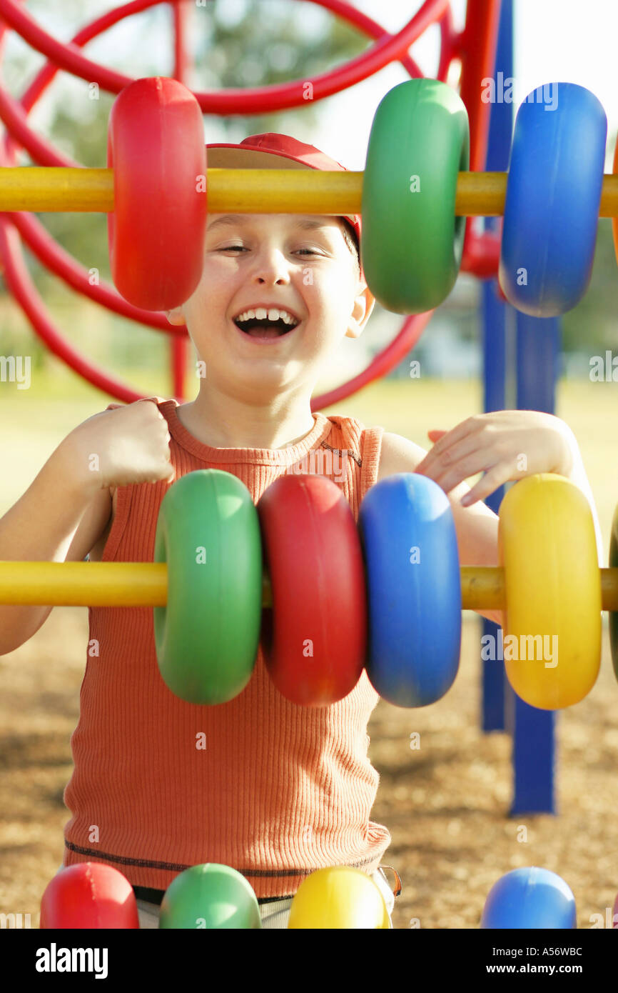 Laughing child spinning colourful loops in playground equipment Stock ...