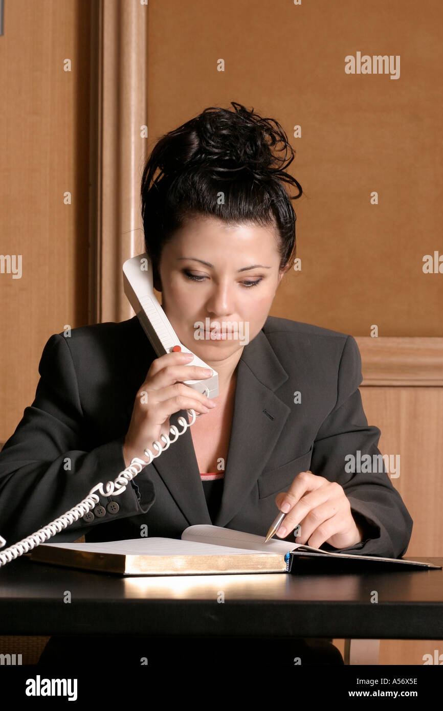 Business professional on phone with schedule diary Stock Photo - Alamy