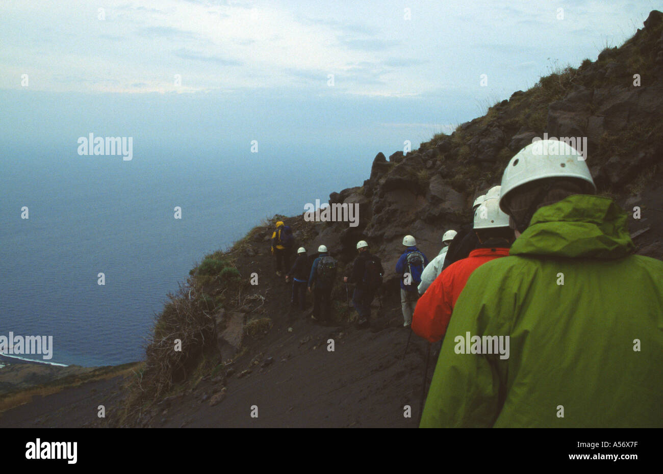 Walkers with volcanologist guide climbing Stromboli Volcano on island ...