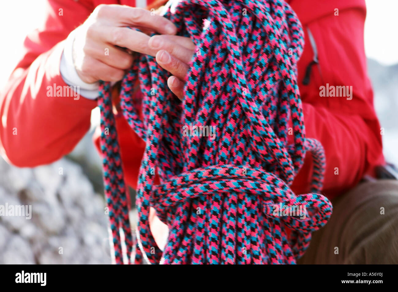 Man holding climbing rope Stock Photo - Alamy