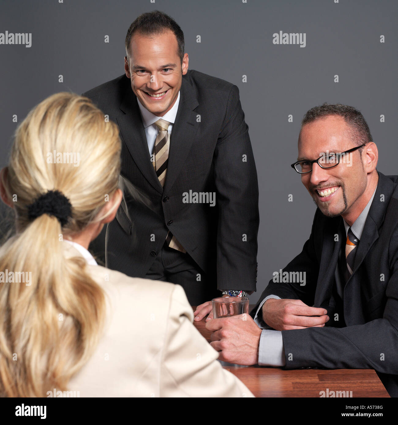 Business people having meeting at conference table, smiling Stock Photo ...