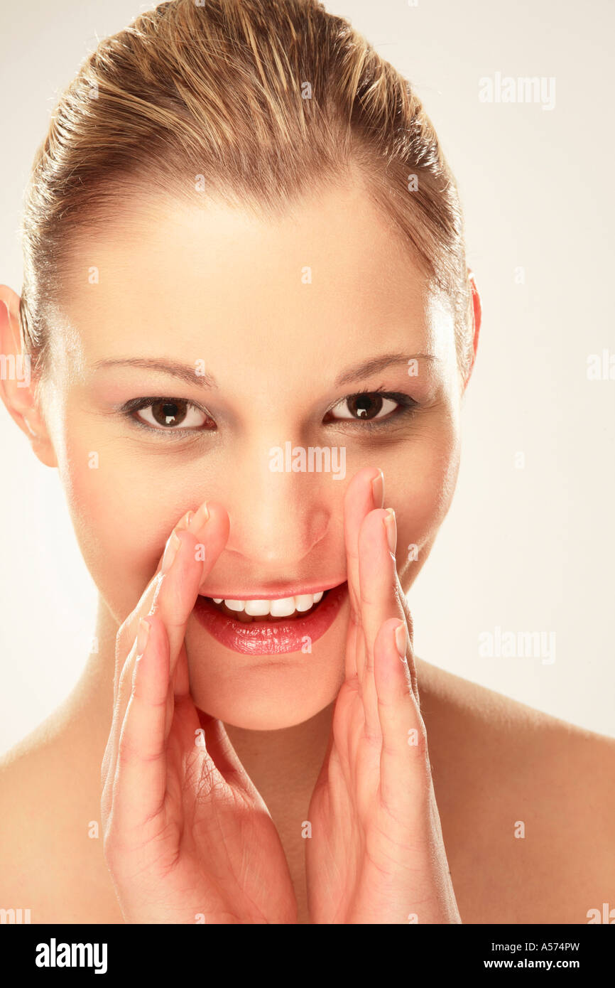 Young woman with hands in face, close-up, portrait Stock Photo - Alamy