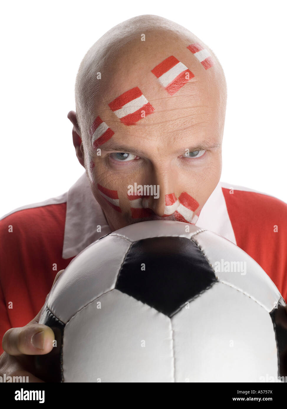 Man with Austrian flag painted on face, kissing football, portrait ...