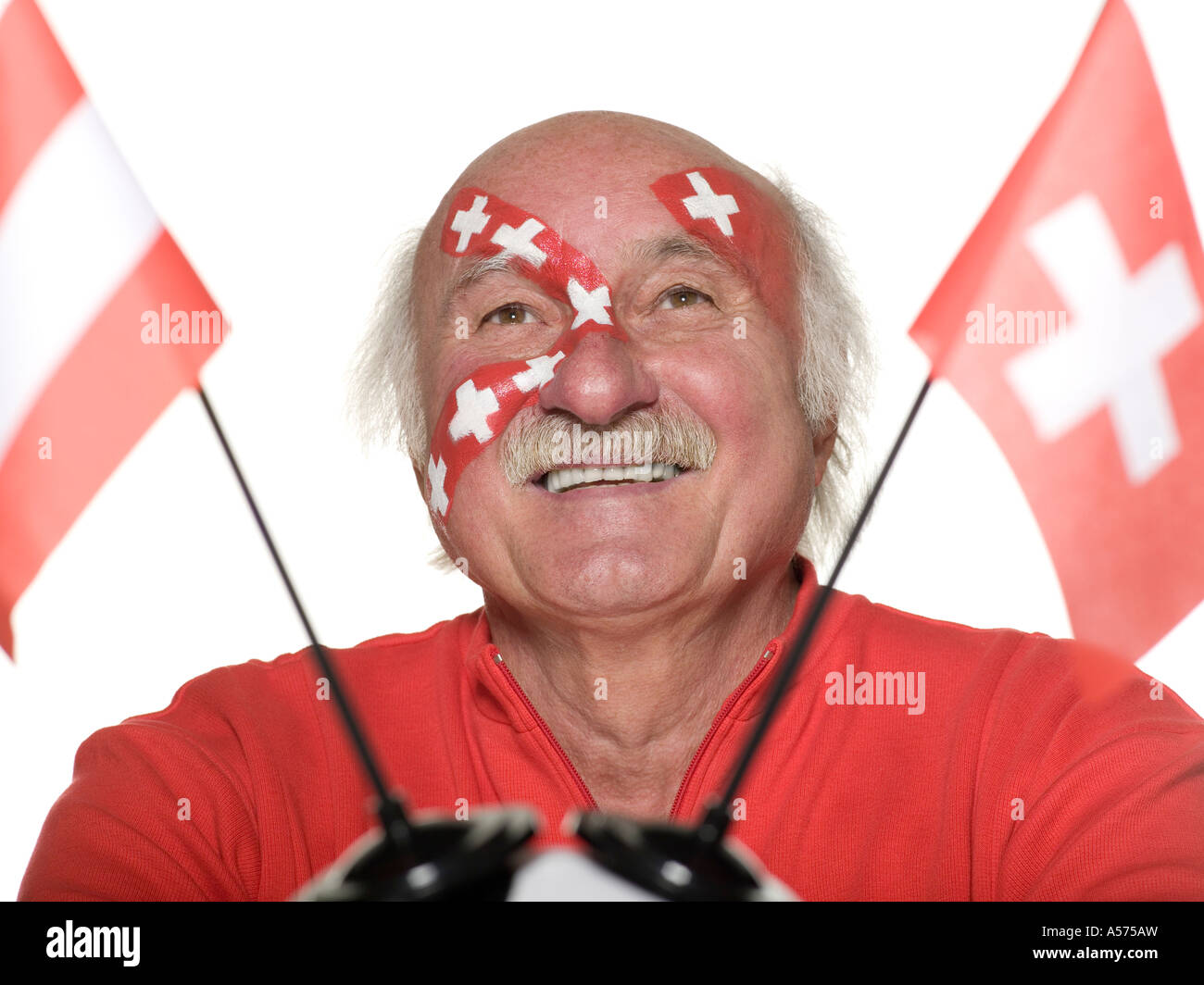 Senior man with Swiss flag painted on face holding football, Austrian ...