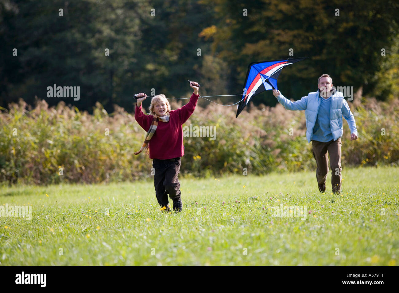 Father and son flying kite Stock Photo - Alamy