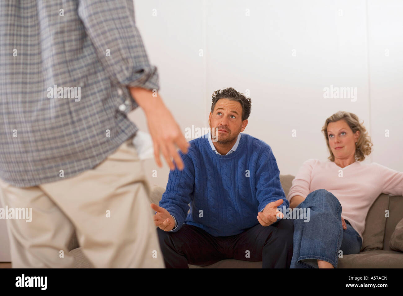Parents discussing with son, rear view Stock Photo - Alamy