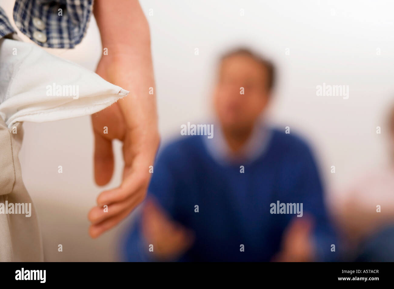 Empty pocket, man in background Stock Photo - Alamy