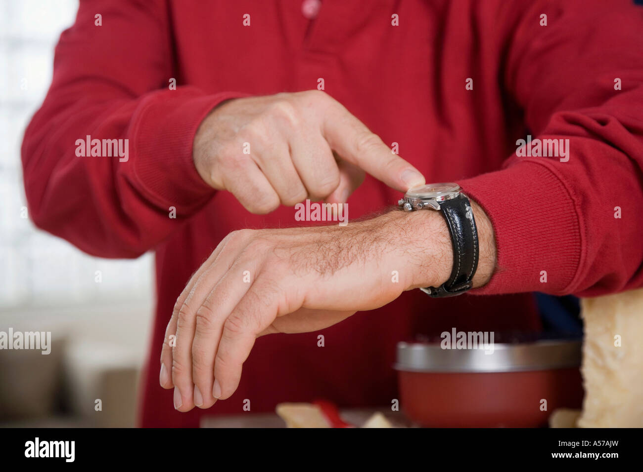 Man pointing on wristwatch Stock Photo - Alamy