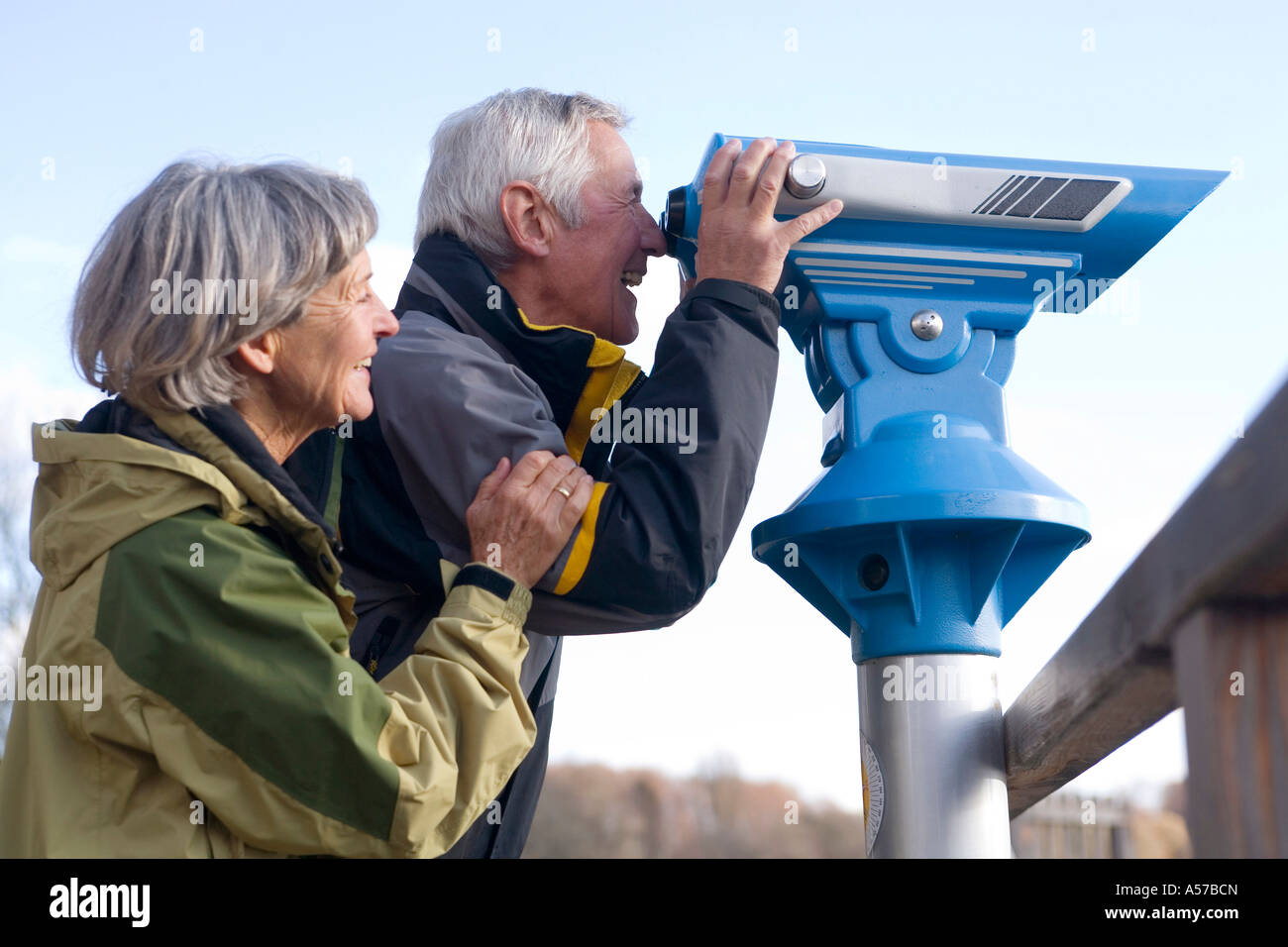 Woman looking through telescope side hi-res stock photography and ...