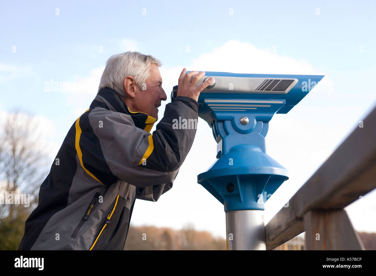Senior adult man looking through telescope, side view Stock Photo - Alamy