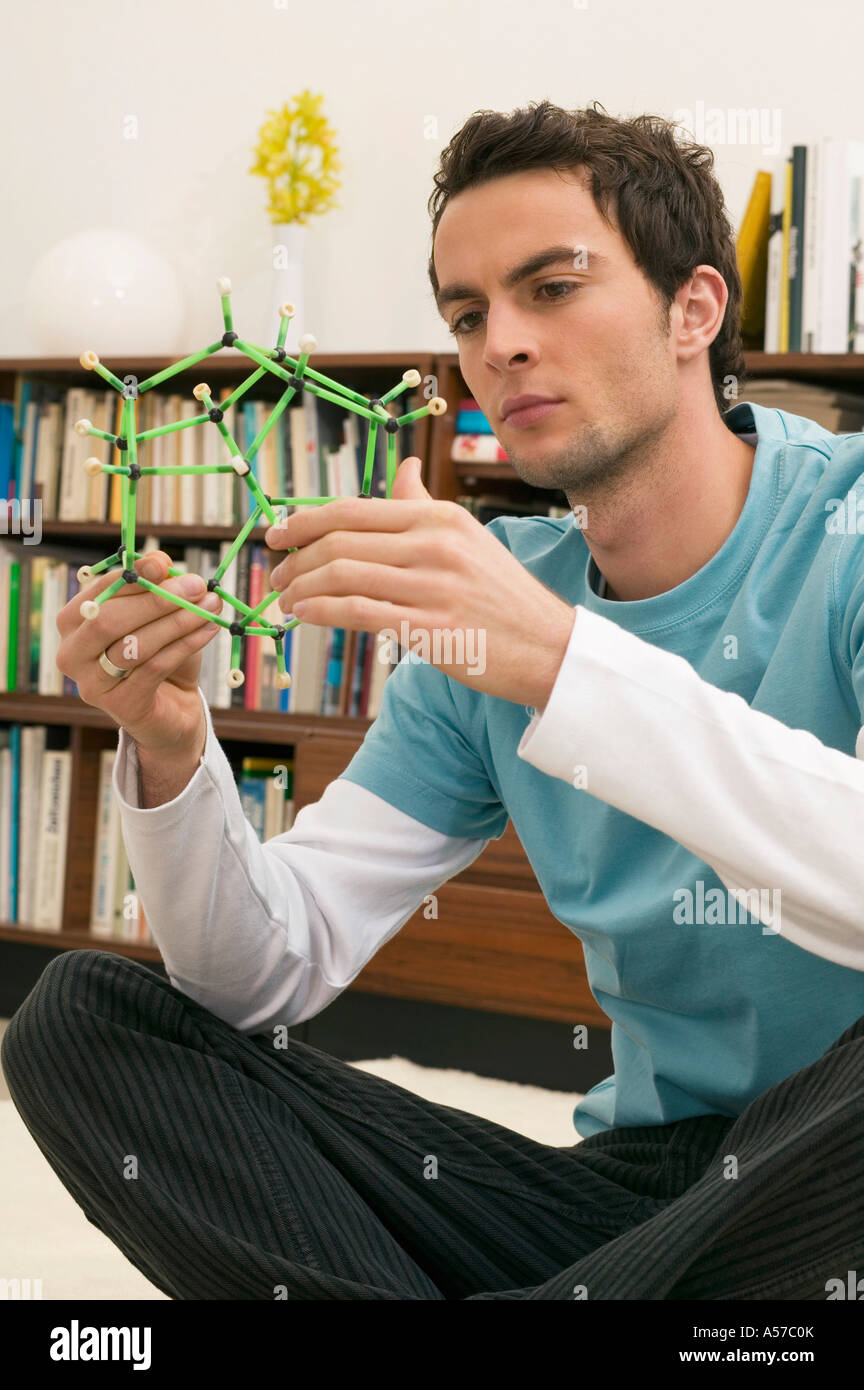 Young man holding model Stock Photo - Alamy