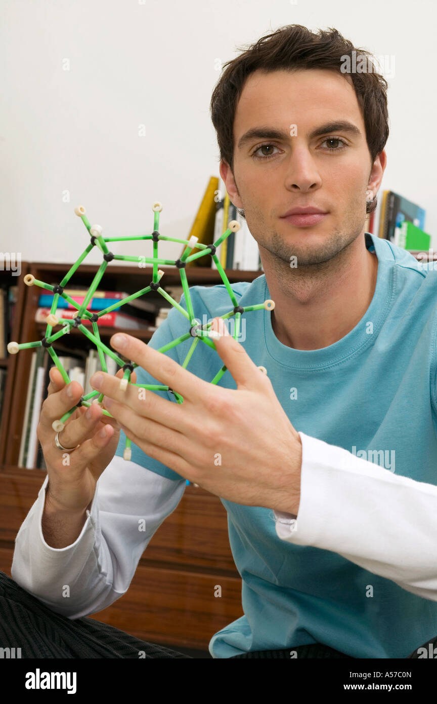 Young man holding model Stock Photo - Alamy