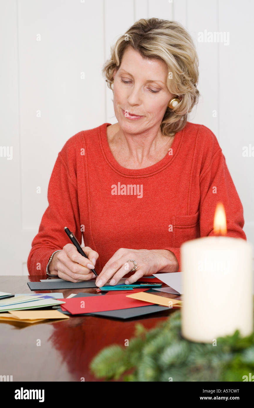 Woman writing Christmas cards Stock Photo - Alamy