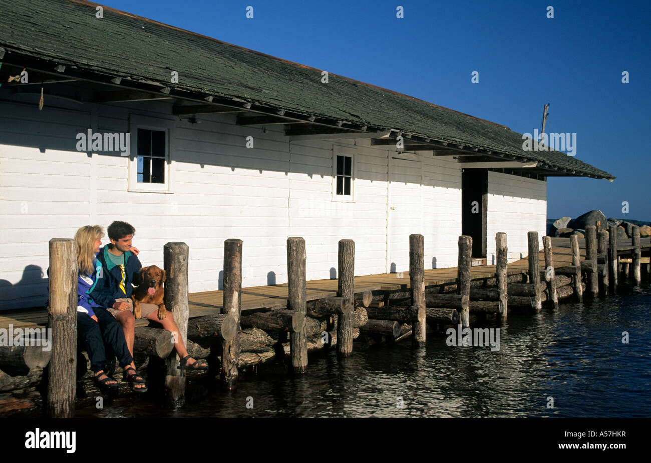 YOUNG COUPLE AND DOG AT HOKENSON BROTHERS FISHERY MUSEUM, APOSTLE ...