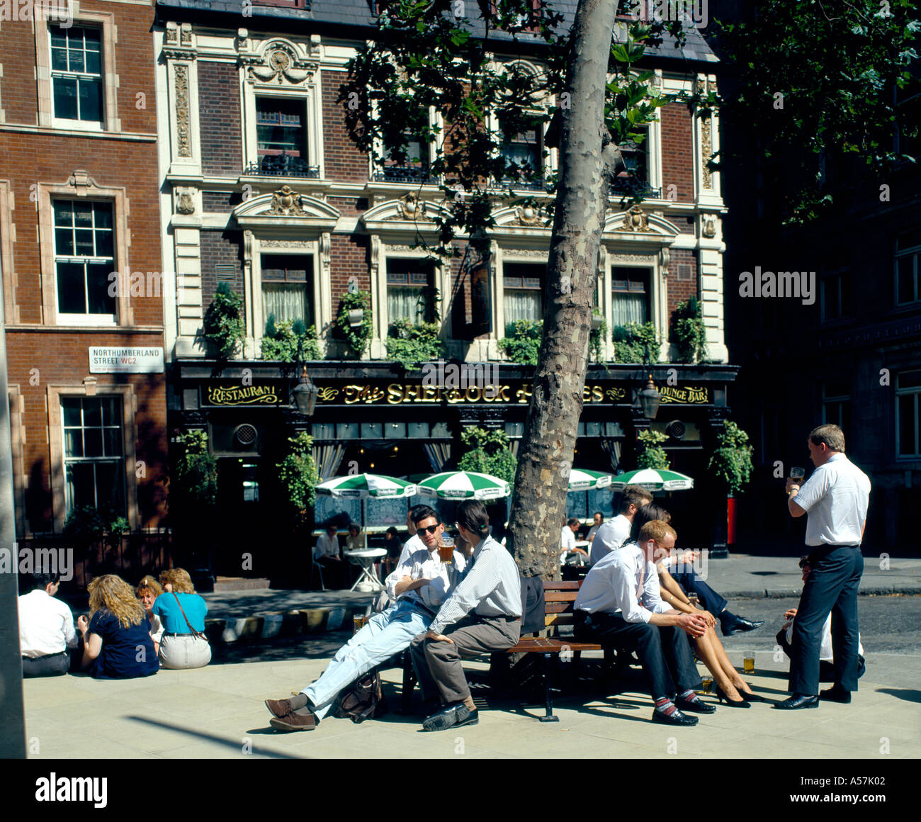 English pub scene people sitting on tree bench outside the Sherlock ...