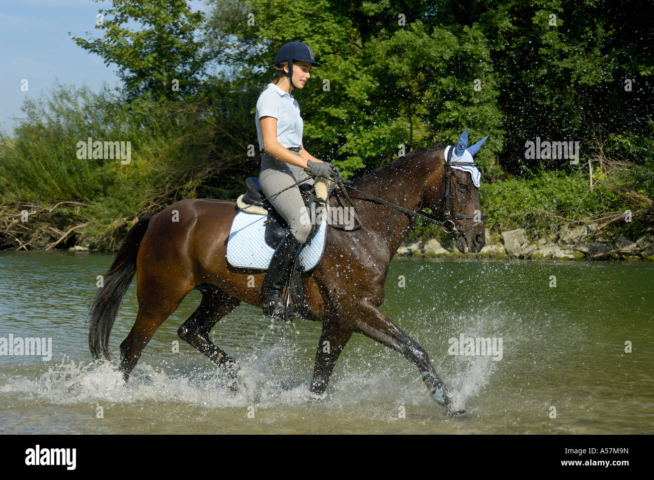 Young lady riding in the Isar river near Moosburg (Bavaria, Germany ...