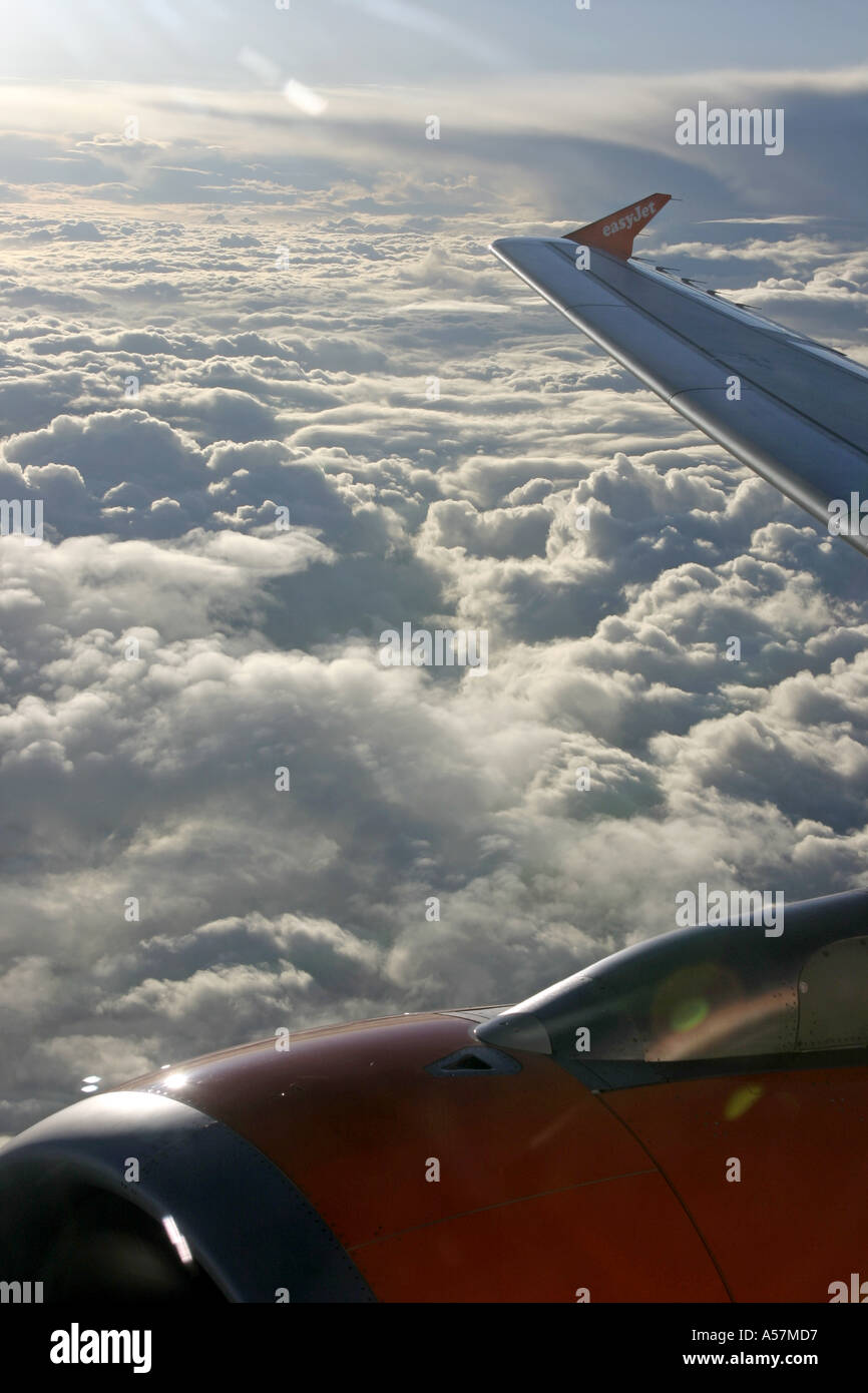 Aerial scenic view of clouds from the air with Easyjet aircraft engine ...