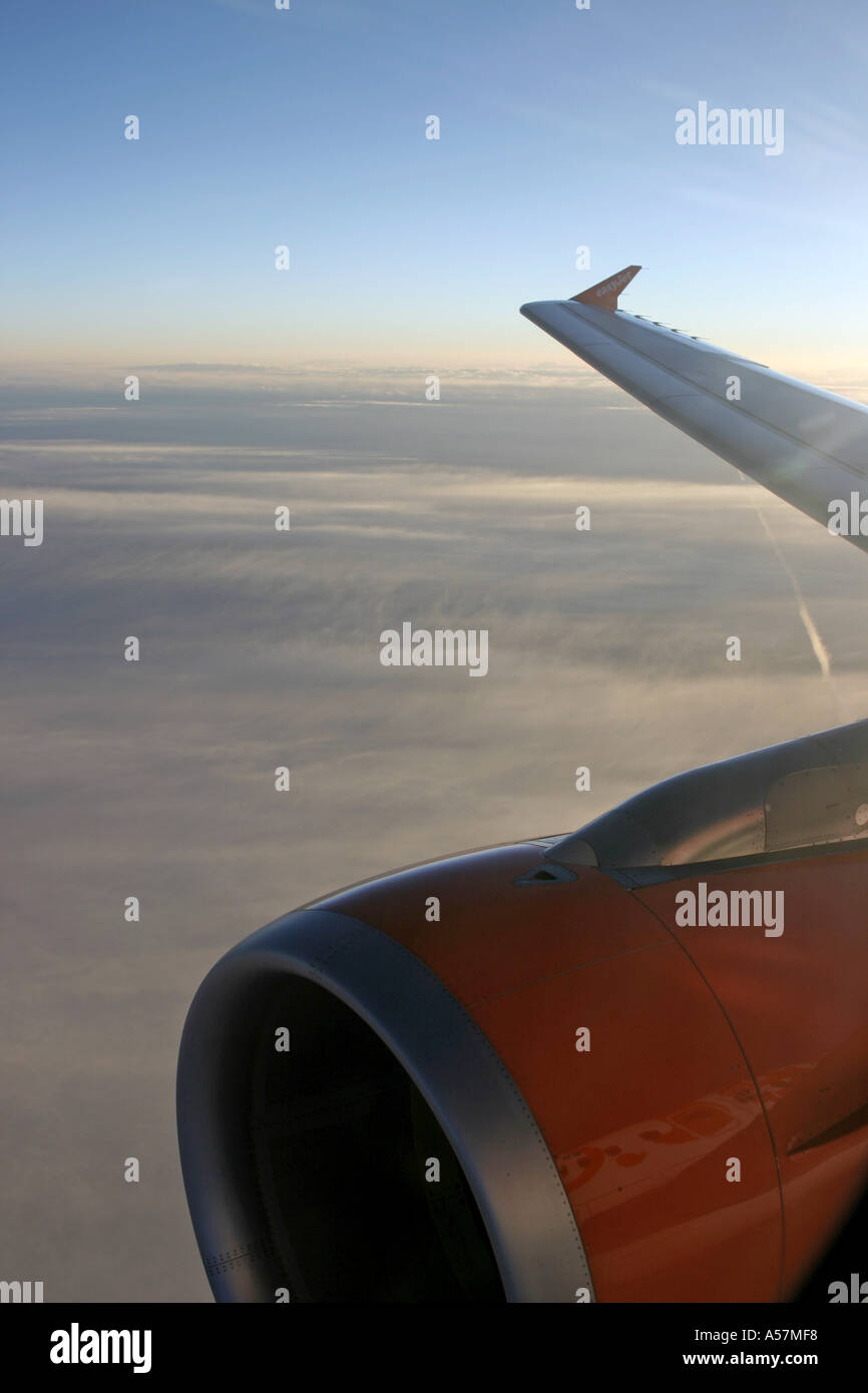 Aerial scenic view of clouds from the air with Easyjet aircraft engine ...