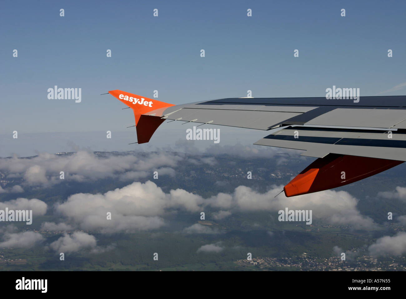 Aerial view of Easyjet aircraft wing and wingtip with sky and clouds ...