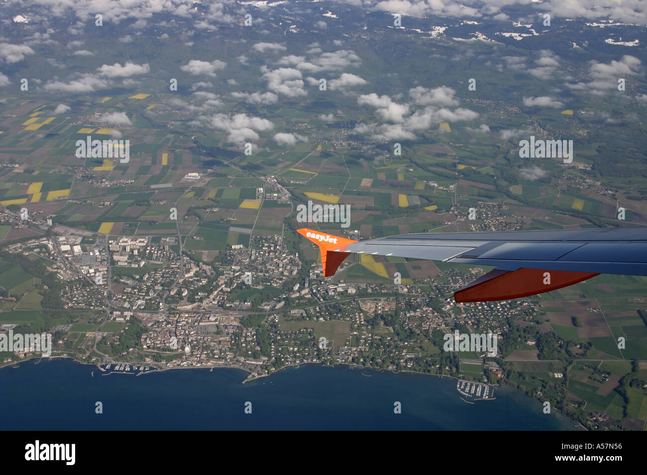 Aerial view of Easyjet aircraft wing and wingtip above Lake Geneva and ...