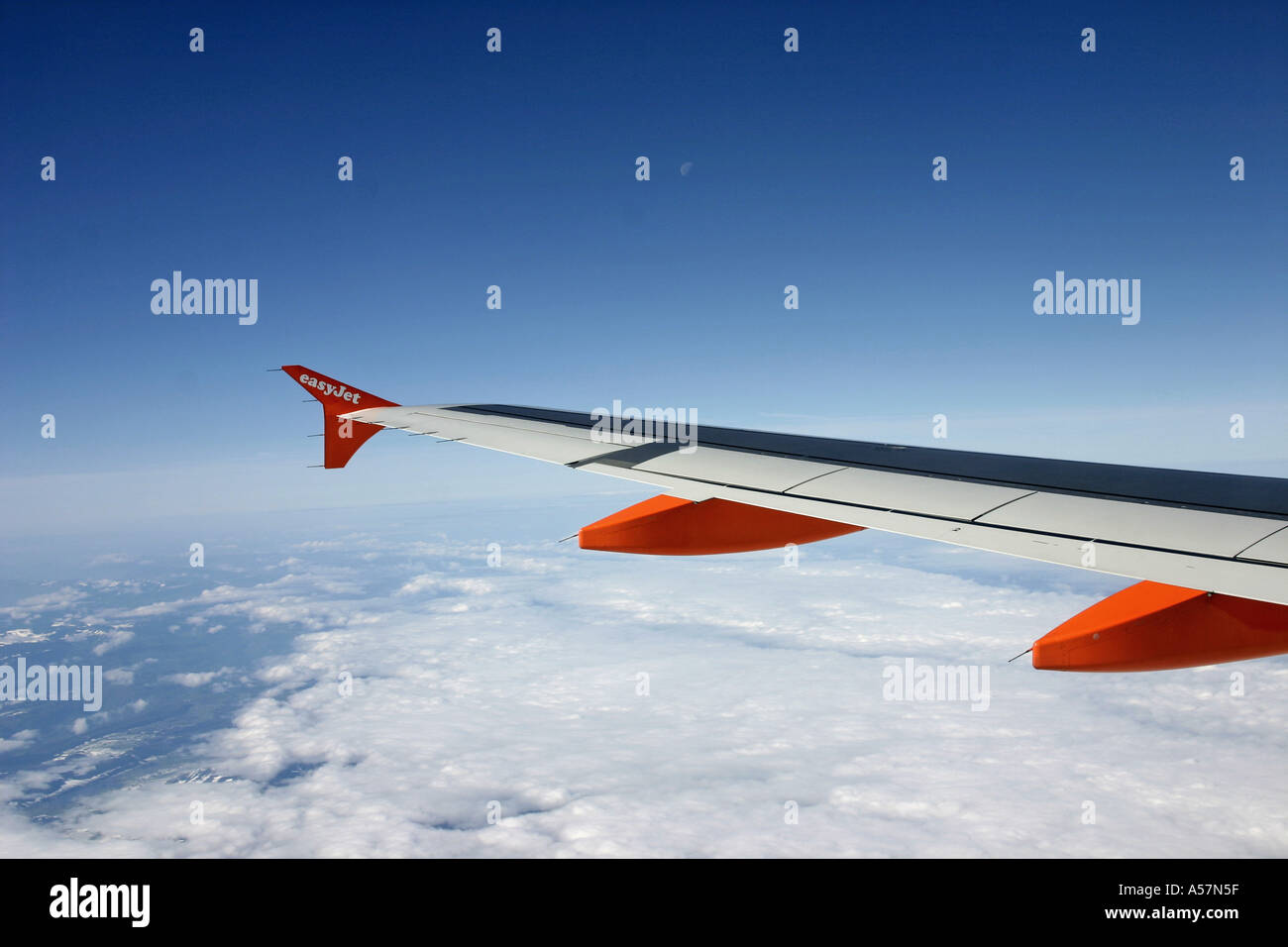 Aerial view of Easyjet aircraft wing and wingtip with sky and clouds ...