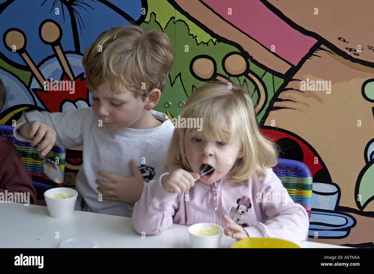 Boy and girl at a children s birthday party tea eating ice cream Stock ...