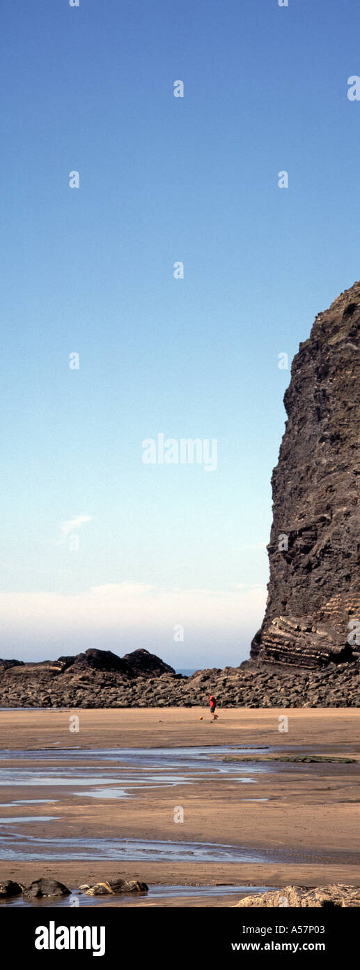 Cornwall bay and cliff with boy and football Stock Photo - Alamy