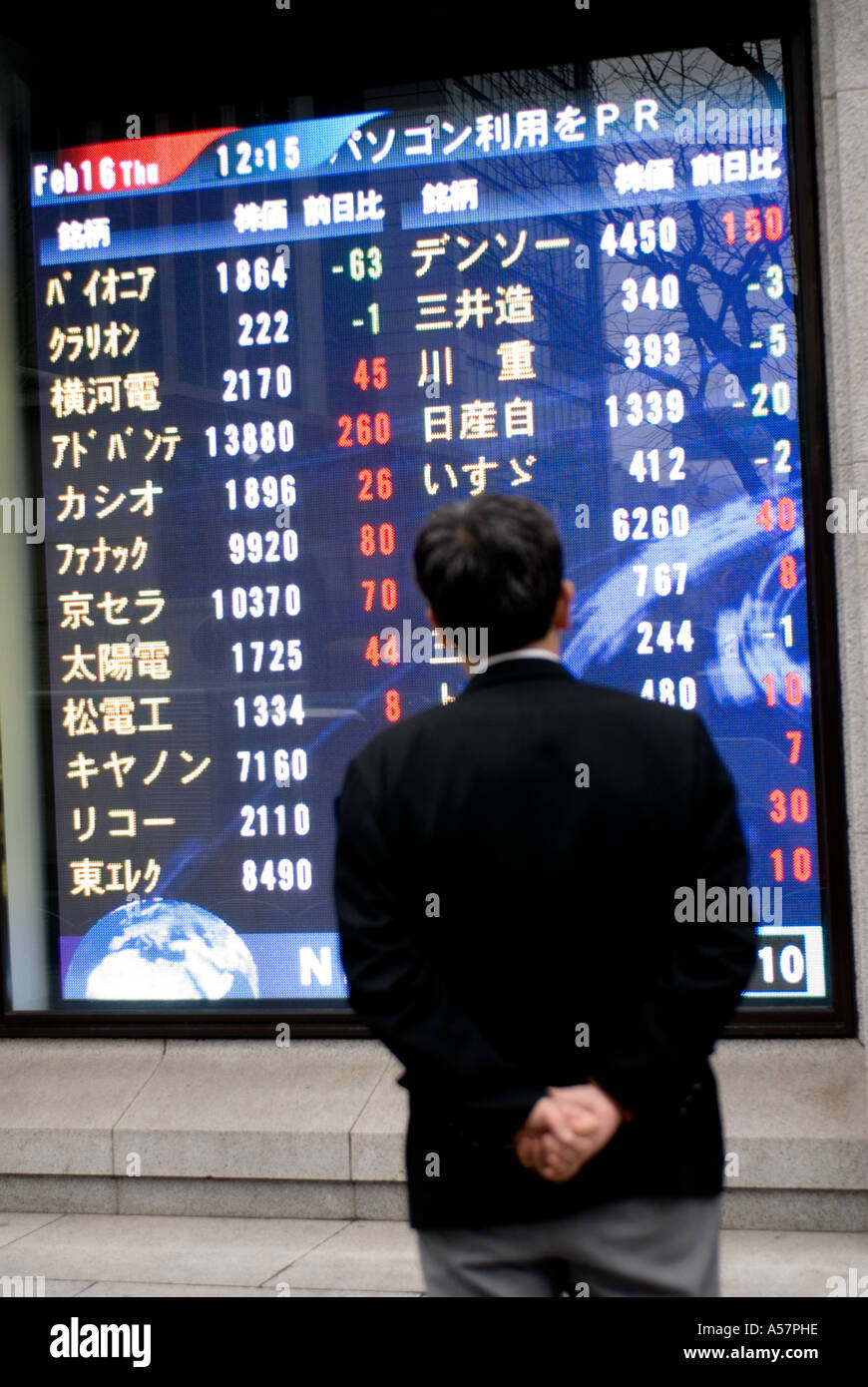 Man looking at stock market index display screen on Tokyo Street Japan ...